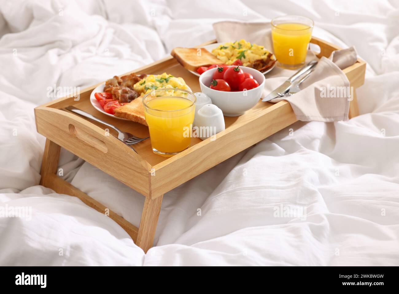 Good morning. Tray with tasty breakfast on bed Stock Photo - Alamy