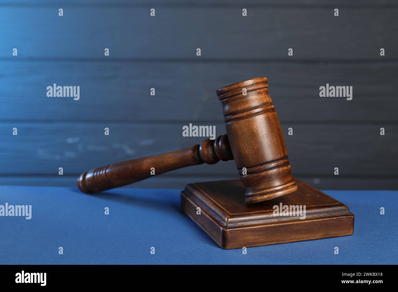 Wooden gavel and sound block on blue table, closeup Stock Photo - Alamy