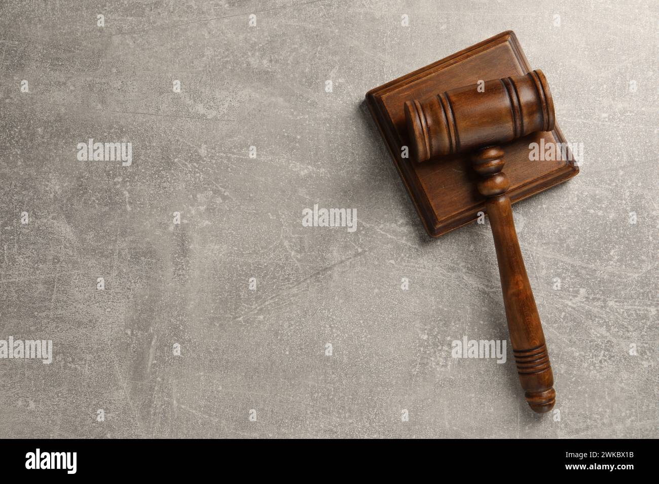 Wooden gavel on grey textured table, top view. Space for text Stock ...