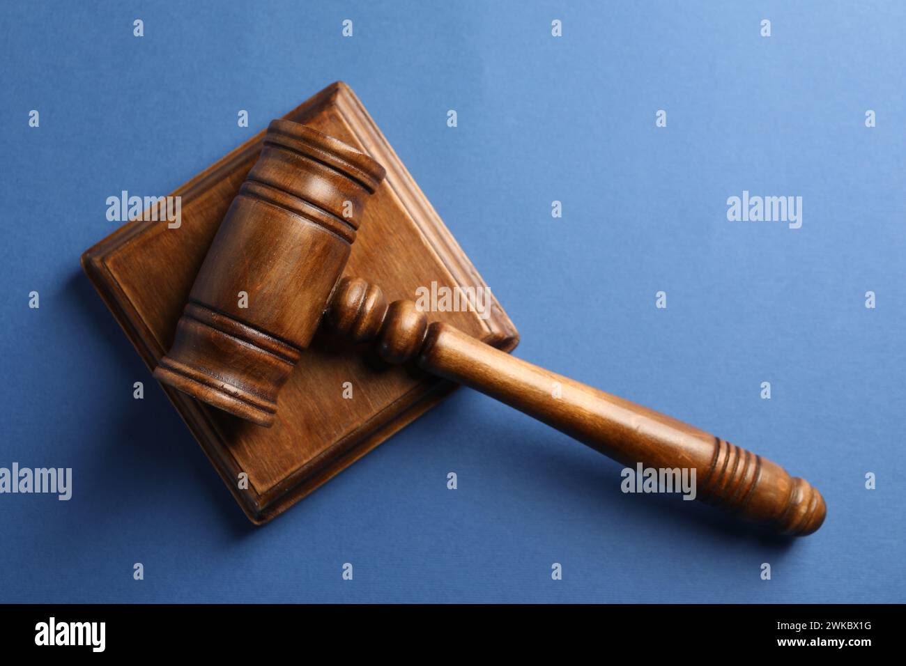 Wooden gavel and sound block on blue table, top view Stock Photo - Alamy
