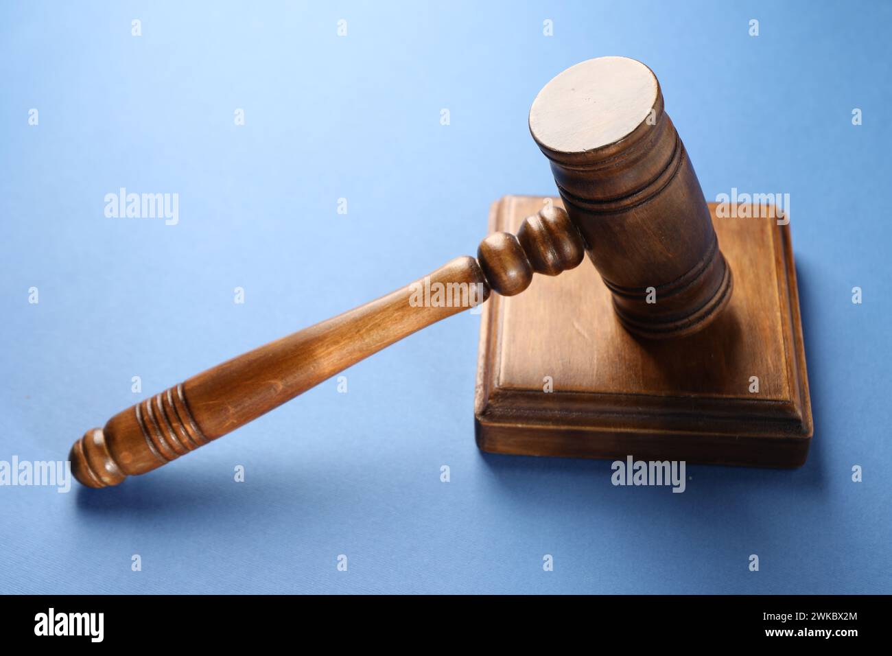 Wooden gavel and sound block on blue table, closeup Stock Photo - Alamy