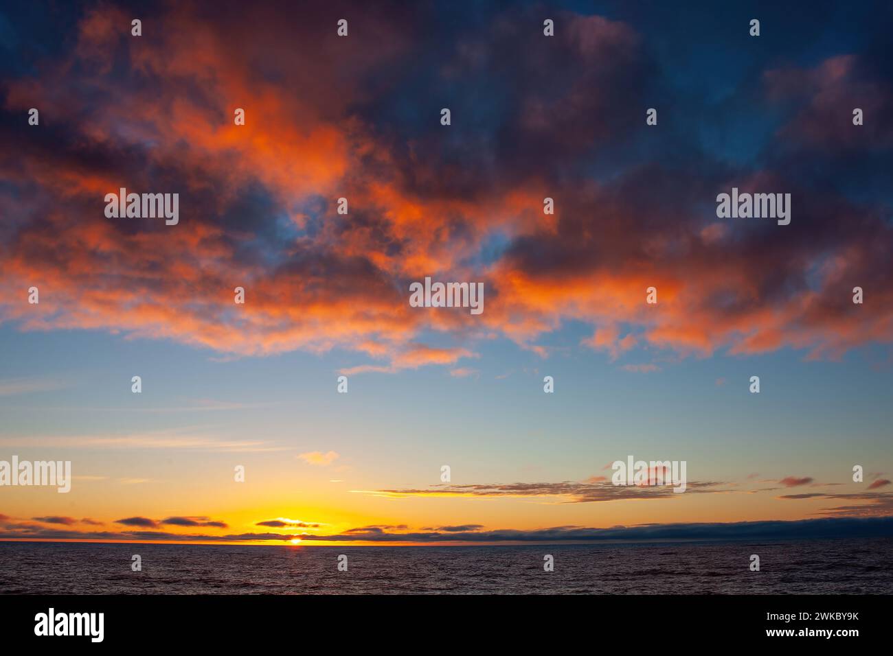 Sunset over an unusually calm Drake Passage, the ocean strait beween ...