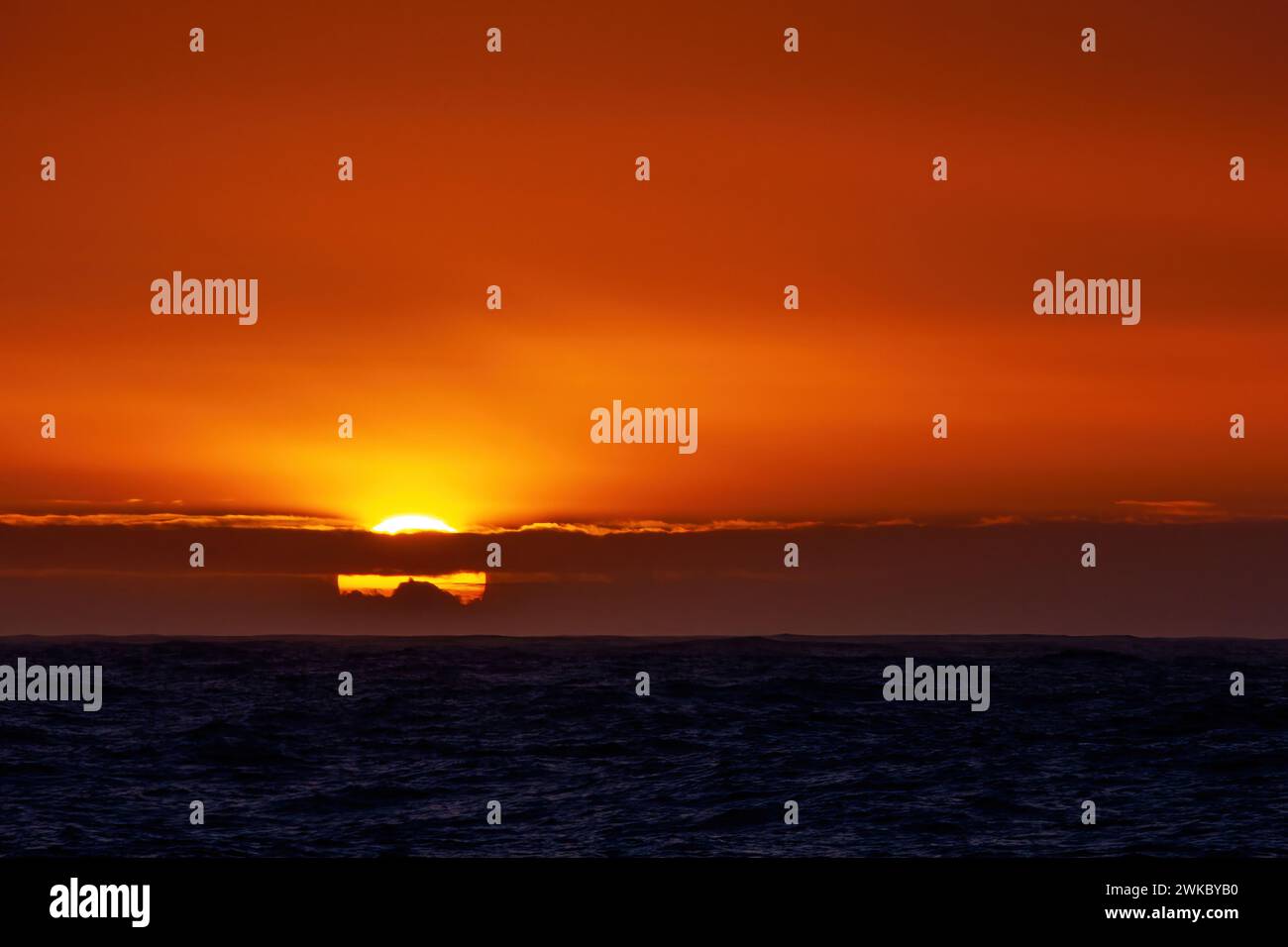 Sunset over an unusually calm Drake Passage, the ocean strait beween ...