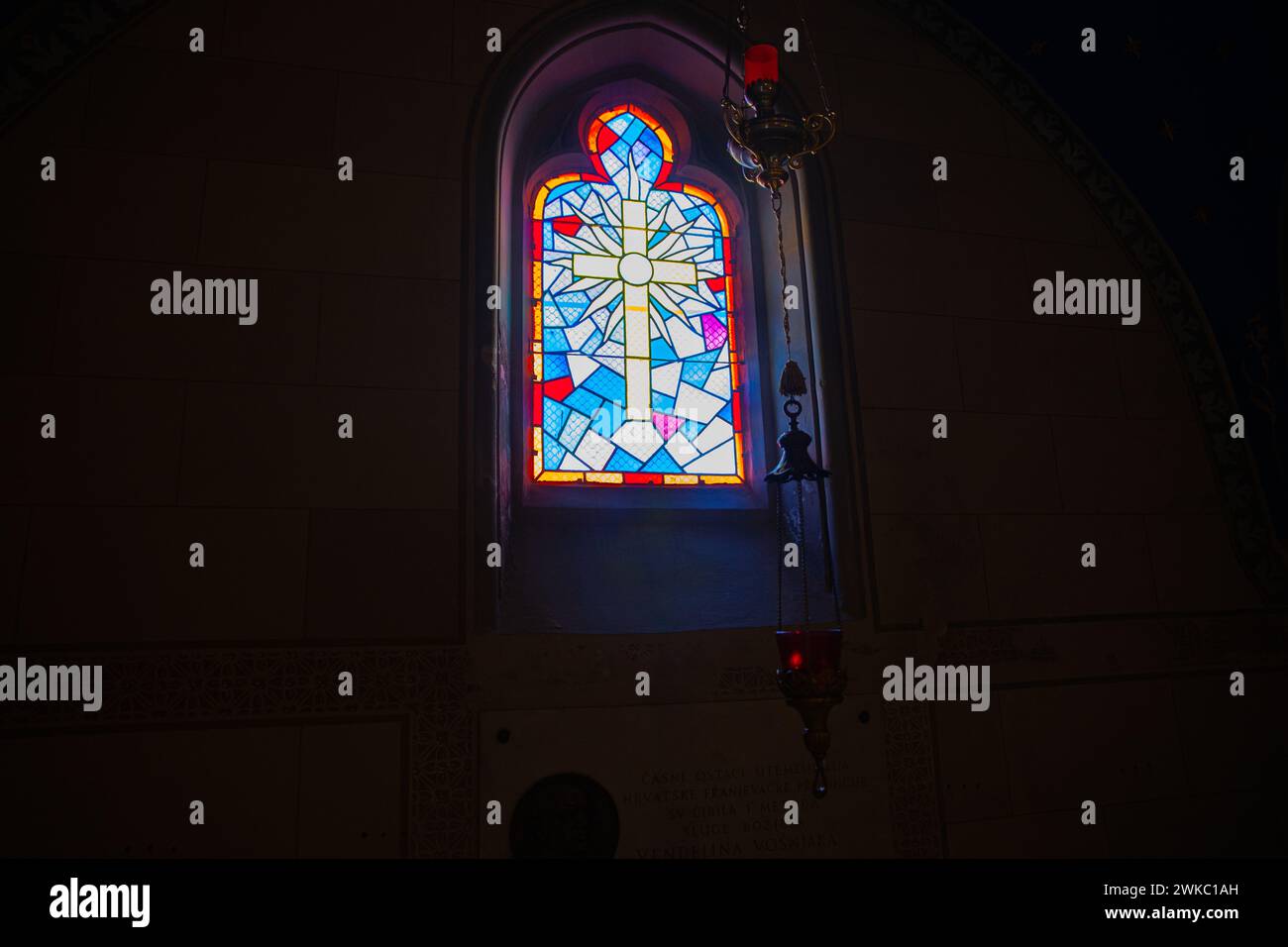 Religious theme cross in leadlight window with colours blue,red and ...