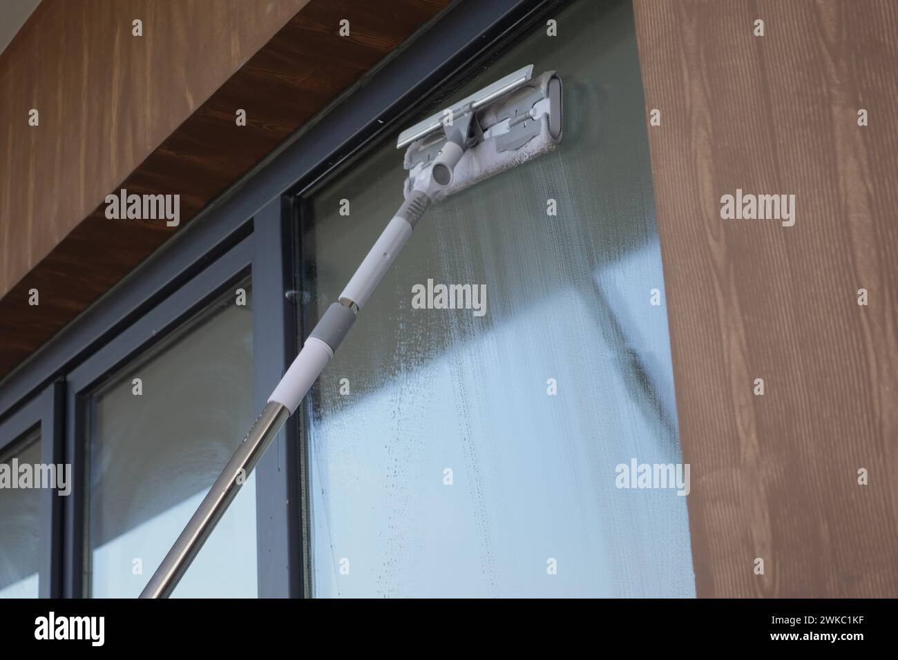 Rubber squeegee cleans a soaped window Stock Photo - Alamy