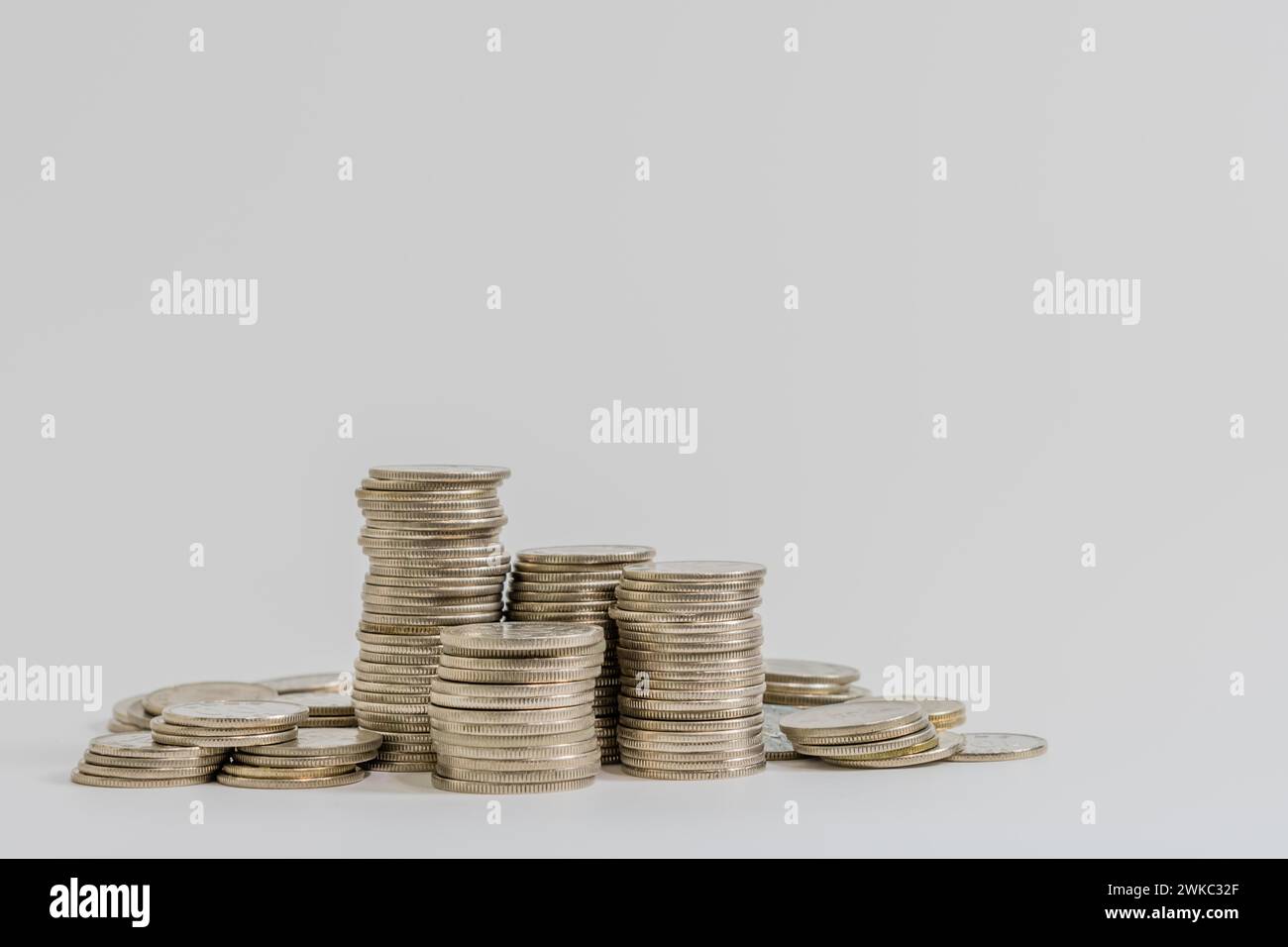 Stacks of coins in various sizes isolated on white background Stock ...