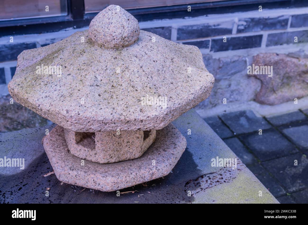 Carved rock lantern on porch step with blurred background in South ...