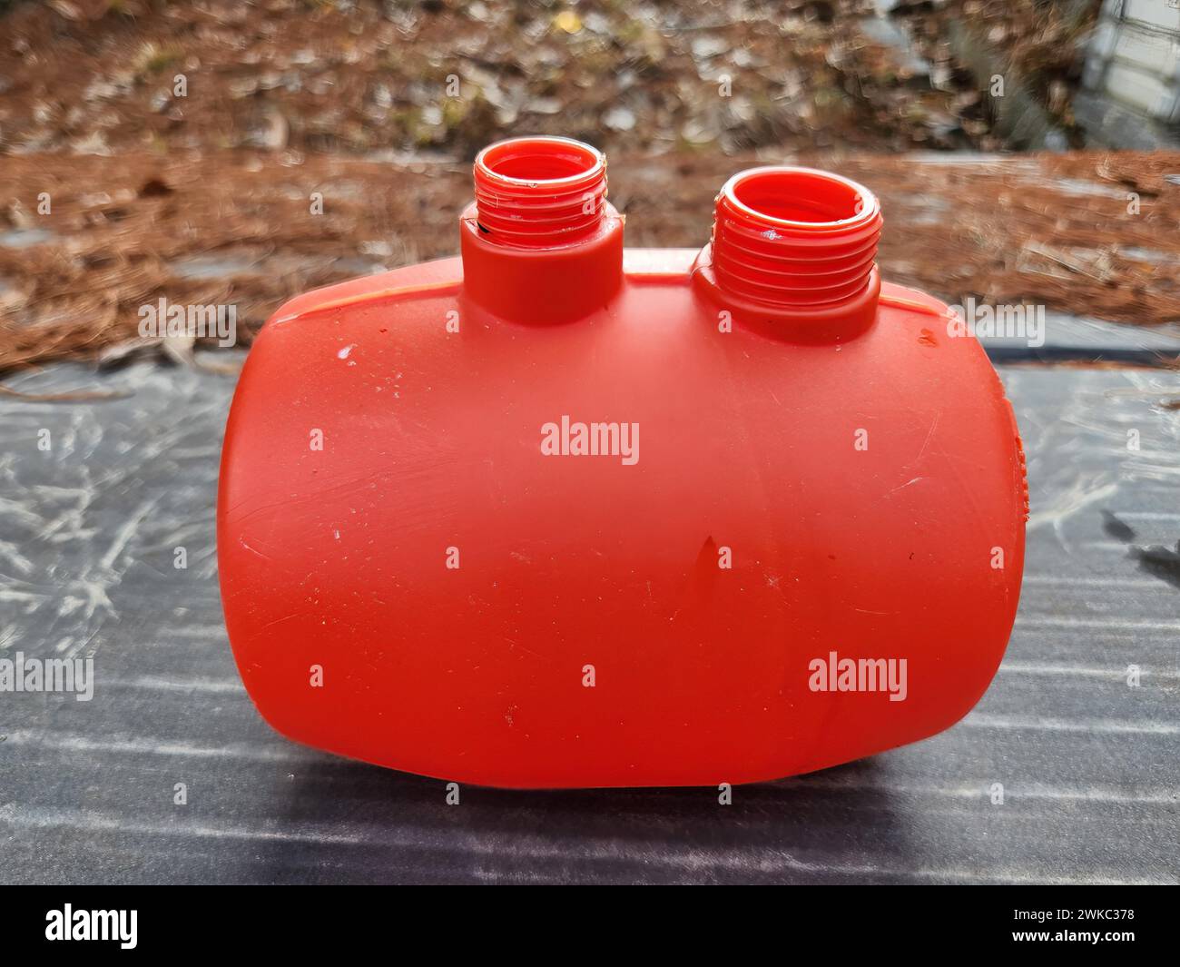 Orange plastic water tank for toy water gun with blurred background in ...