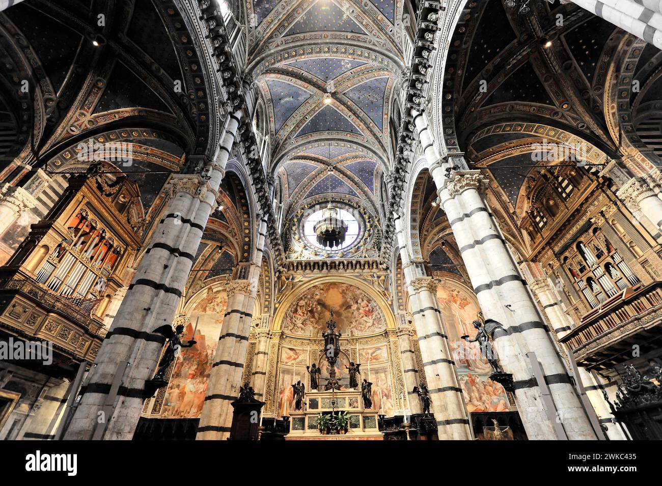 The nave of the cathedral with its black and white striped marble ...