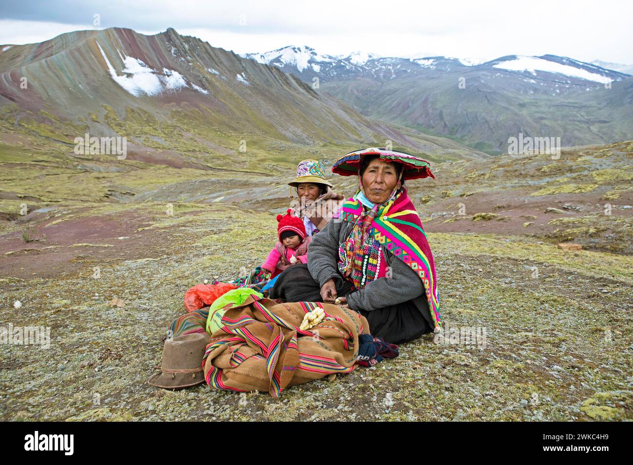 Peruvian woman, 55 and 27 years old, in traditional dress sit with a ...