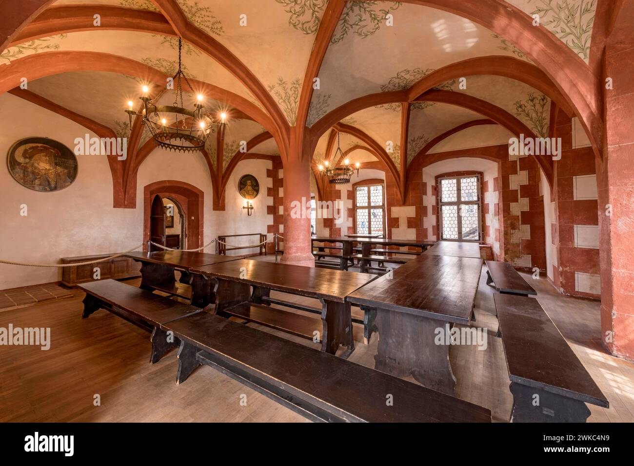 Court parlour with cross vaulting, chandelier, solid wooden tables and ...