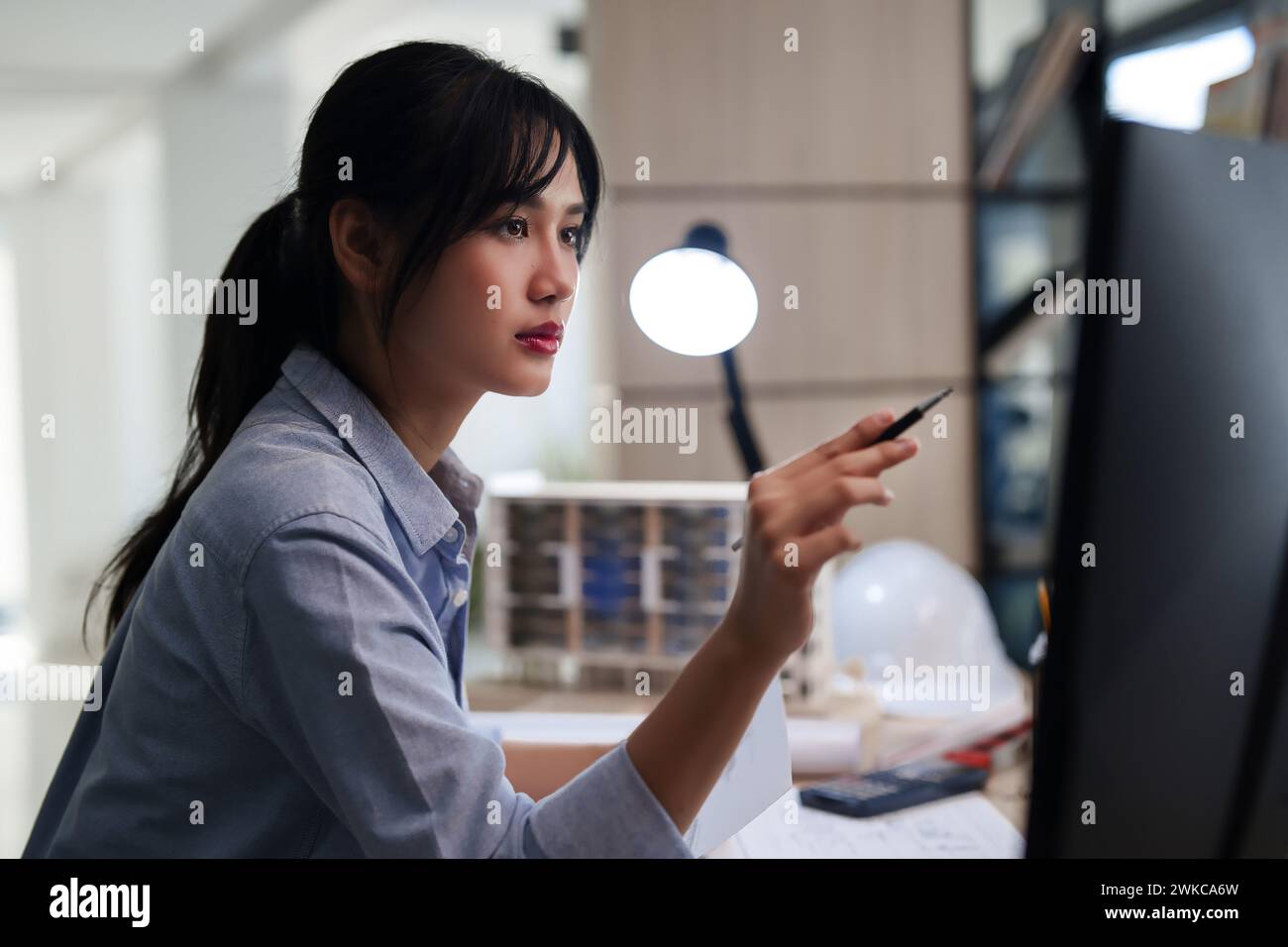 Asian architect engineer women pointing on monitor of computer to ...