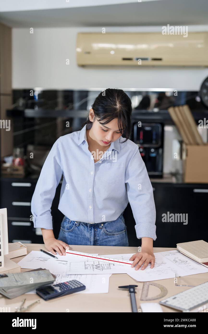 Asian architect engineer women working to designing new project about ...