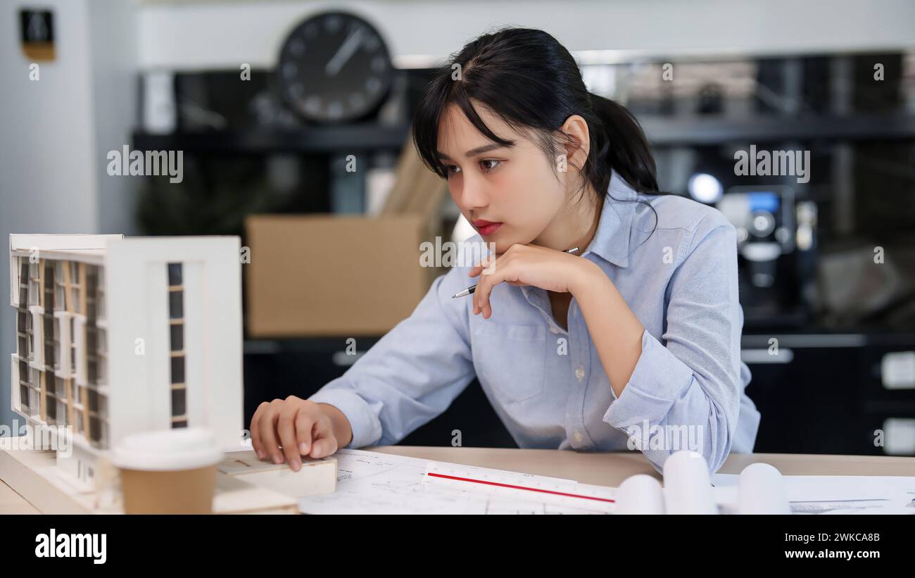 Asian architect engineer women working to examining design of ...