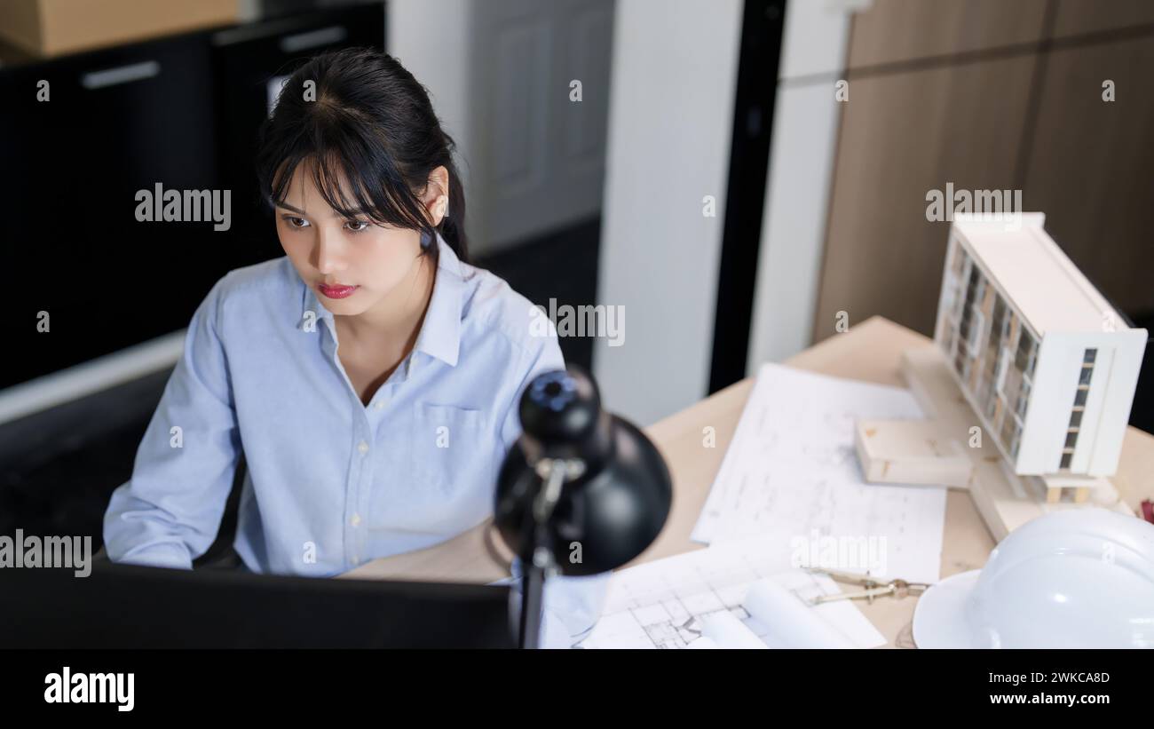 Asian architect engineer women using computer to typing information ...