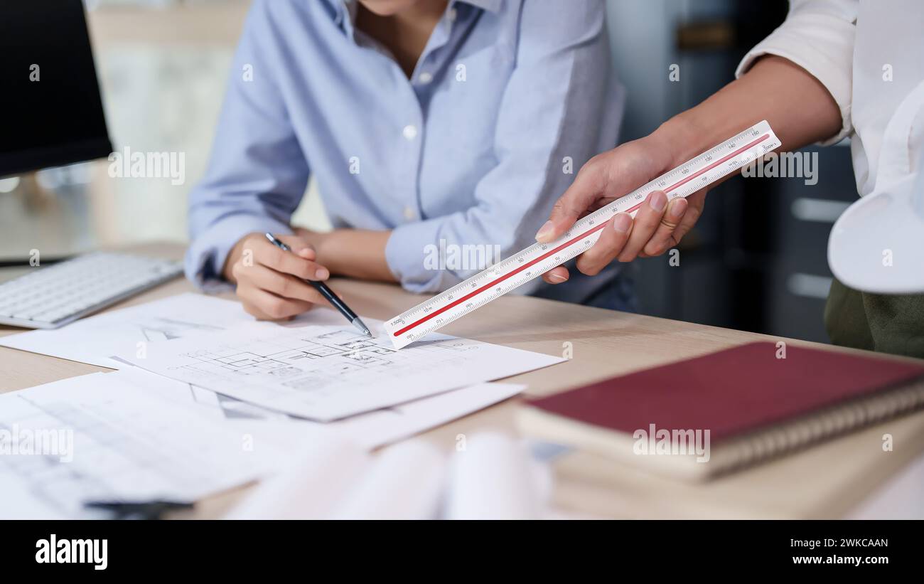 Two asian architect engineer discussion about drawing architecture plan ...