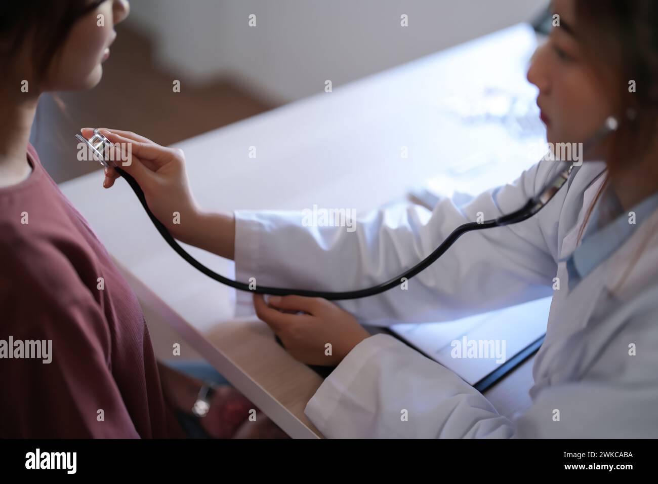 Asian psychologist women use stethoscope to examining heartbeat of ...