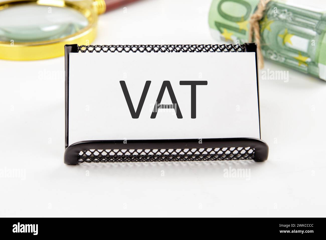 VAT the text on the business card next to the roll of money with a ...