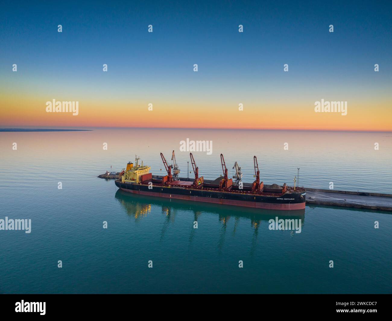Aerial view of the industrial port of Alcanar on a winter sunset ...