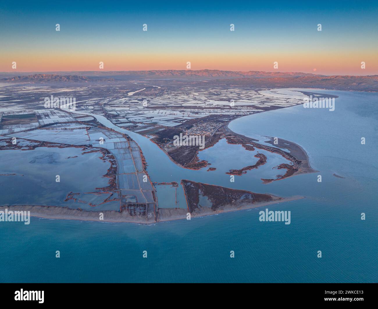 Sunrise over the mouth of the Ebro River in the Ebro Delta with the ...