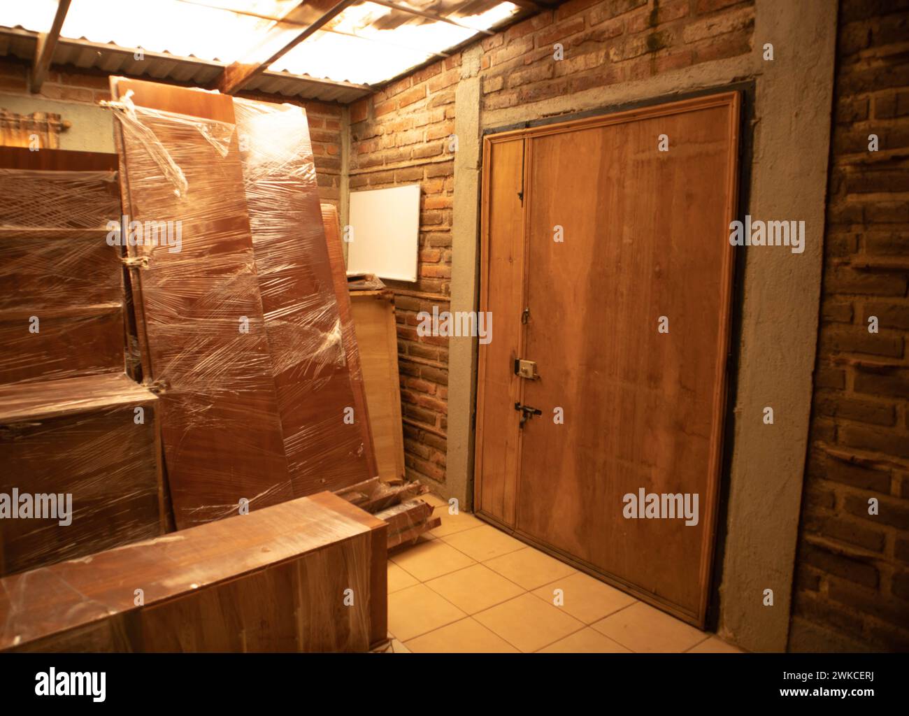 Utility room full of boxes with brick walls Stock Photo - Alamy