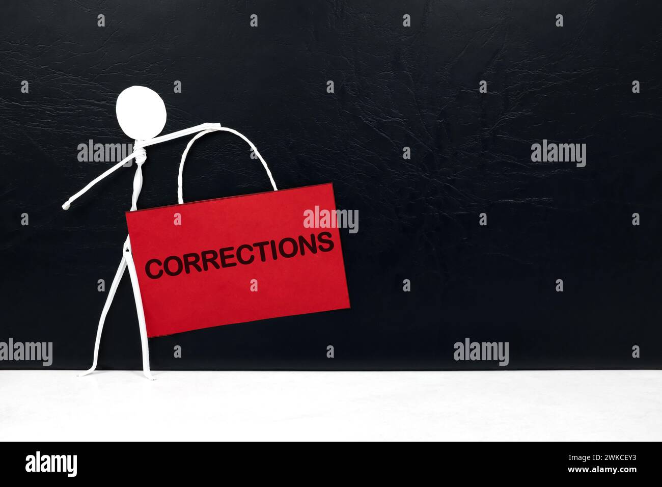 Stick figure holding corrections placard in black background. Audit ...