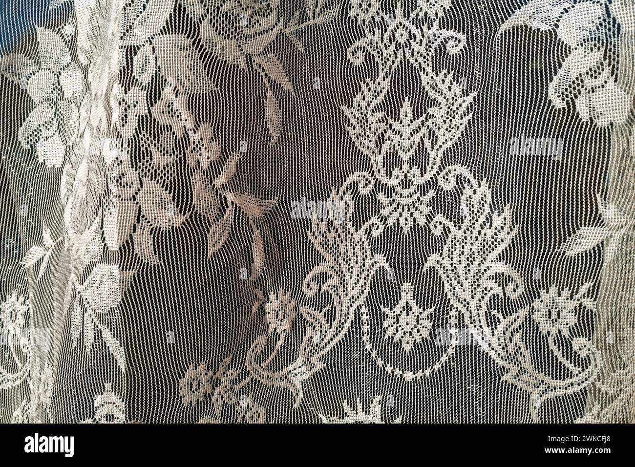 Detail of the intricate patterns in an antique lace curtain hanging in ...
