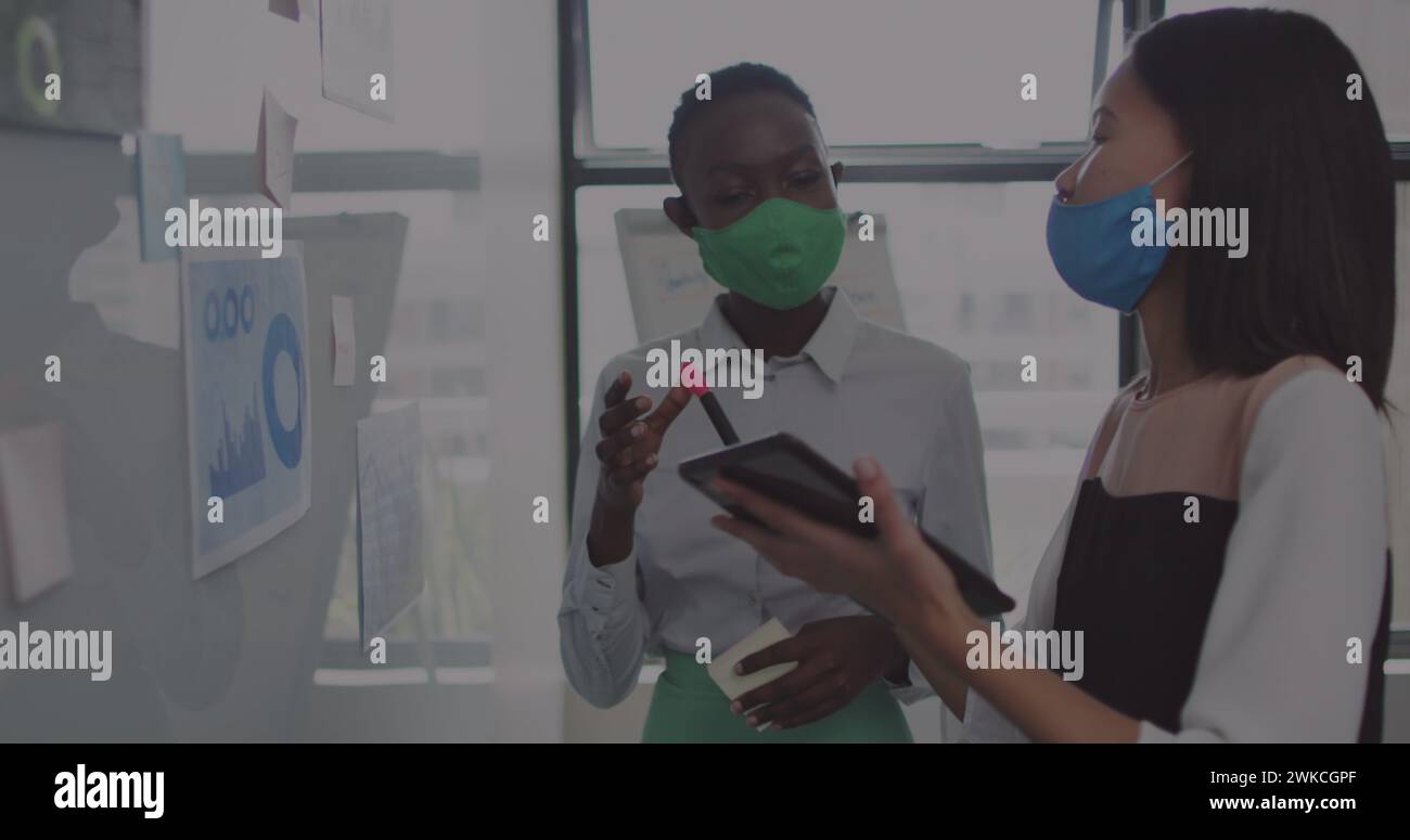 Image of financial data processing over diverse businesswomen with face ...