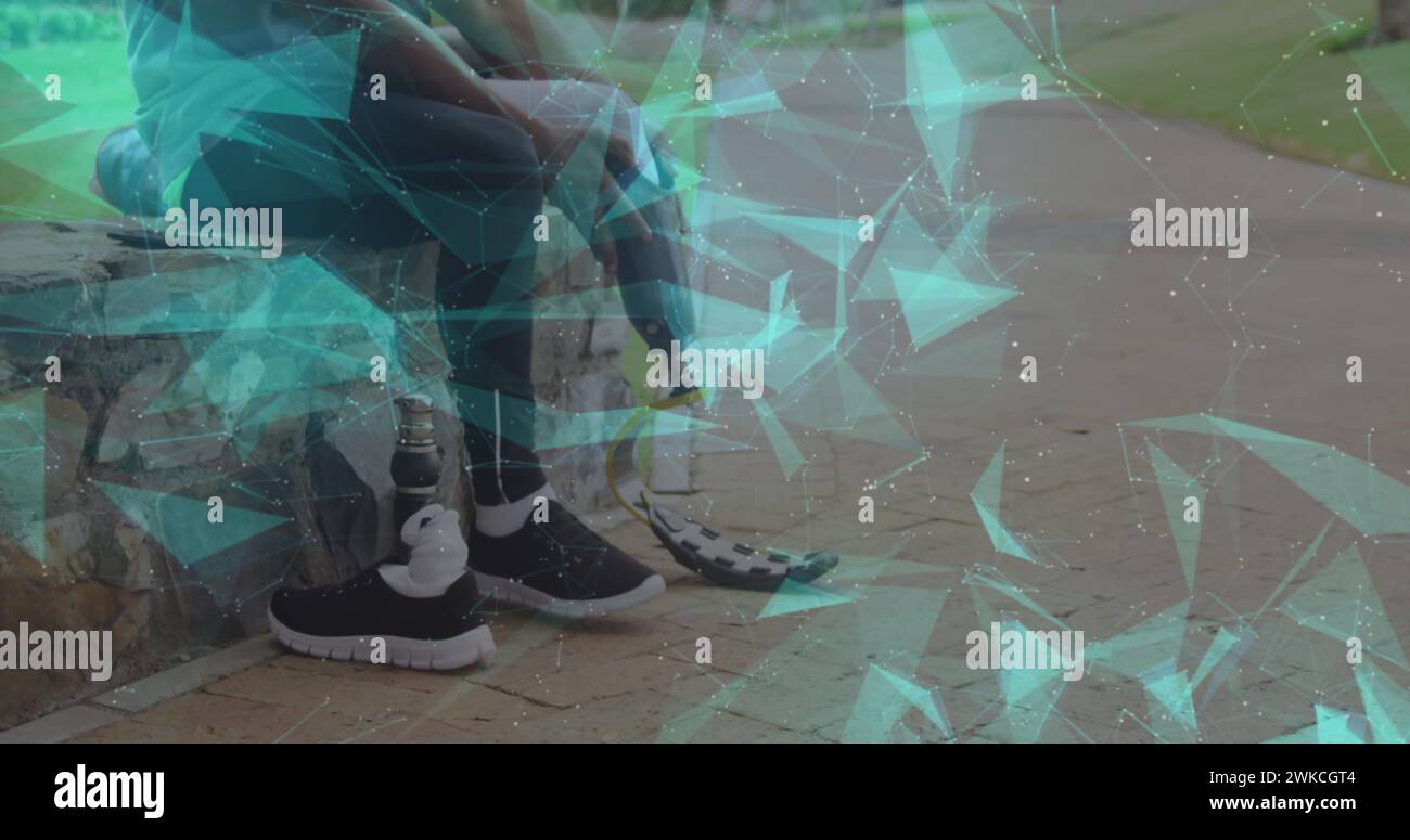 Image of floating network over male athlete preparing running blade for ...