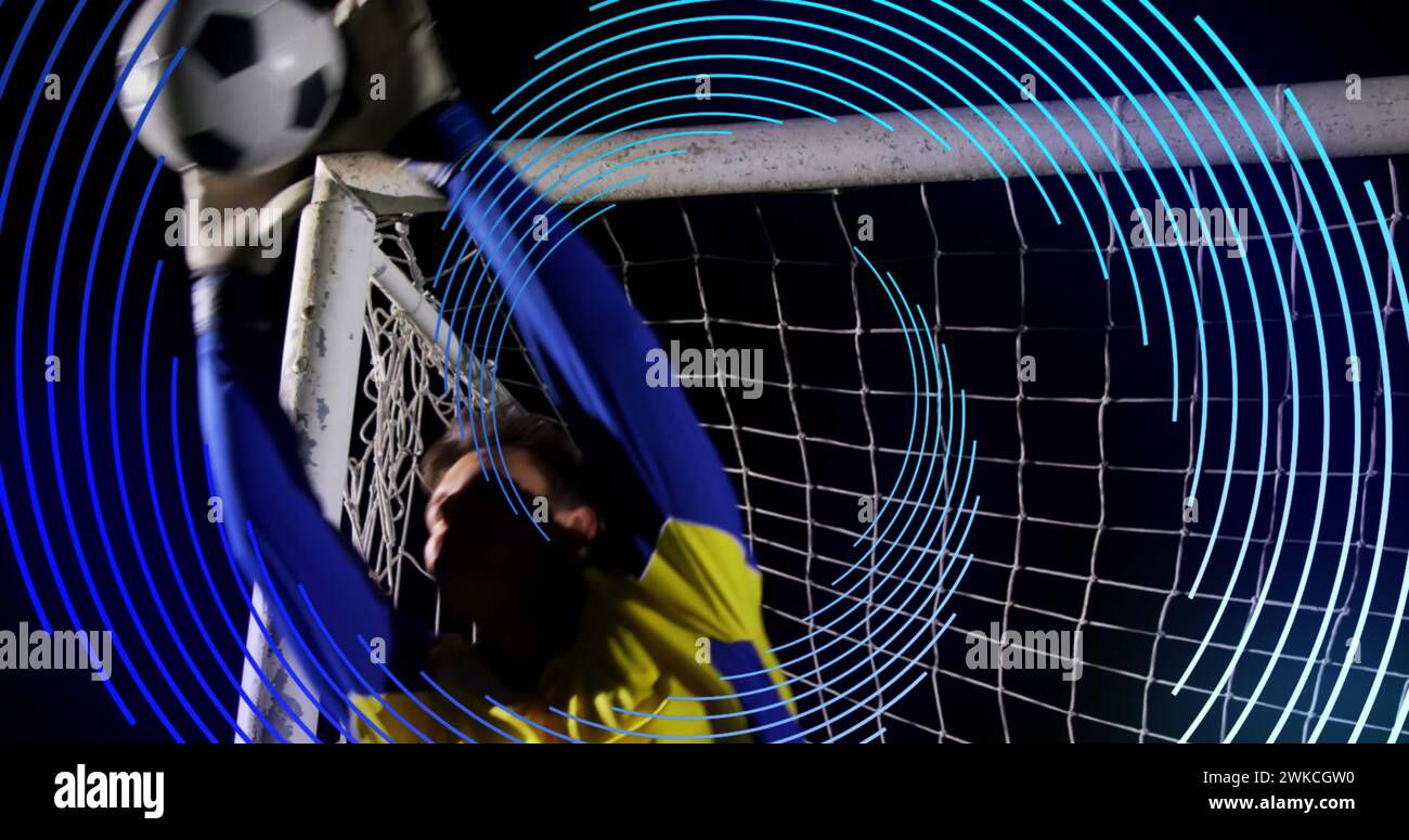 Image of blue line spiral rotating over male football goalkeeper saving ...