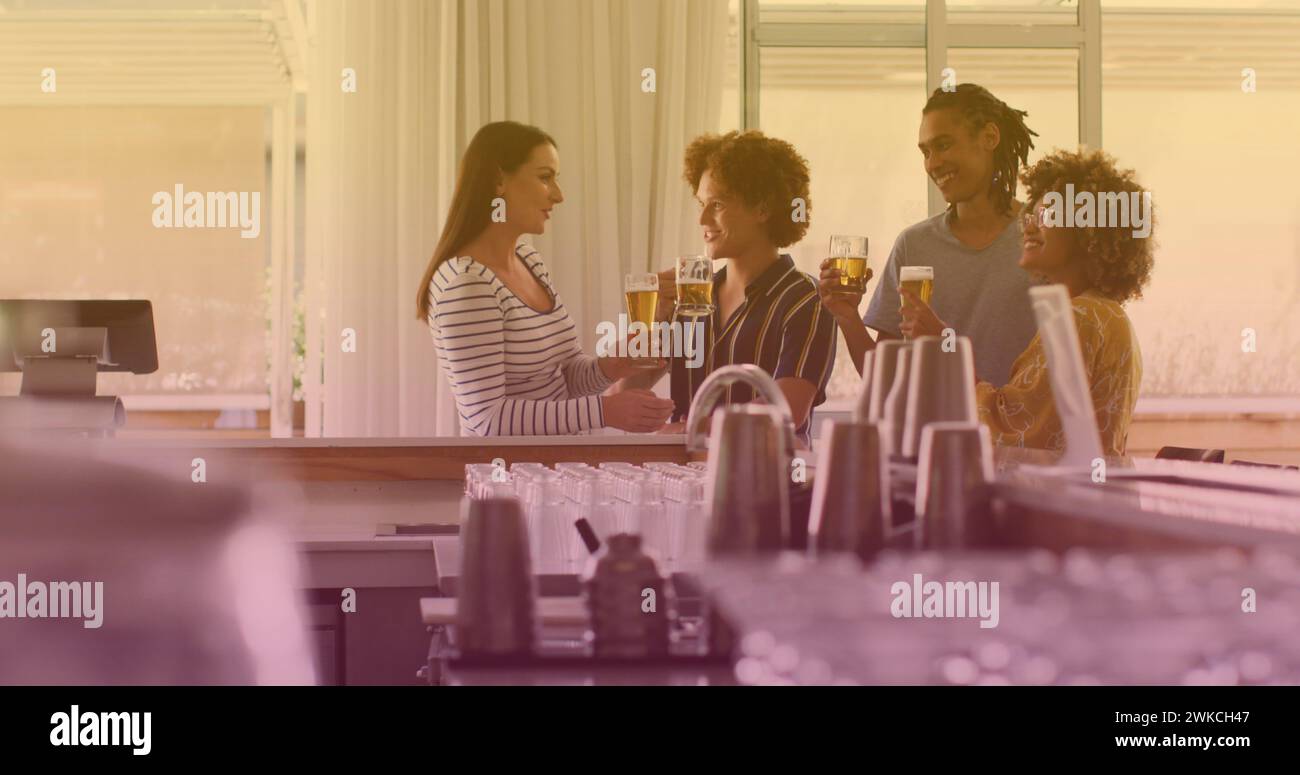 Friends enjoy drinks at a bar, with copy space Stock Photo - Alamy