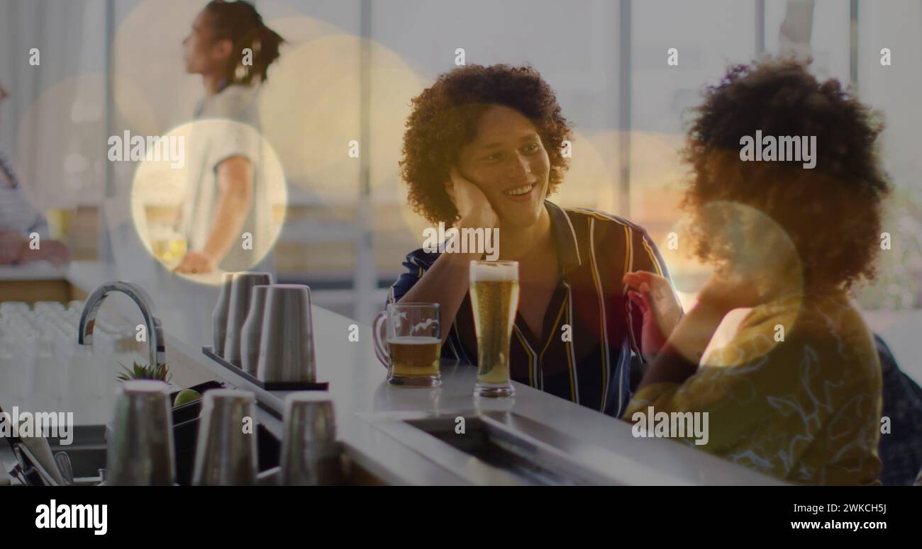Image of light spots over happy diverse friends drinking beer Stock ...