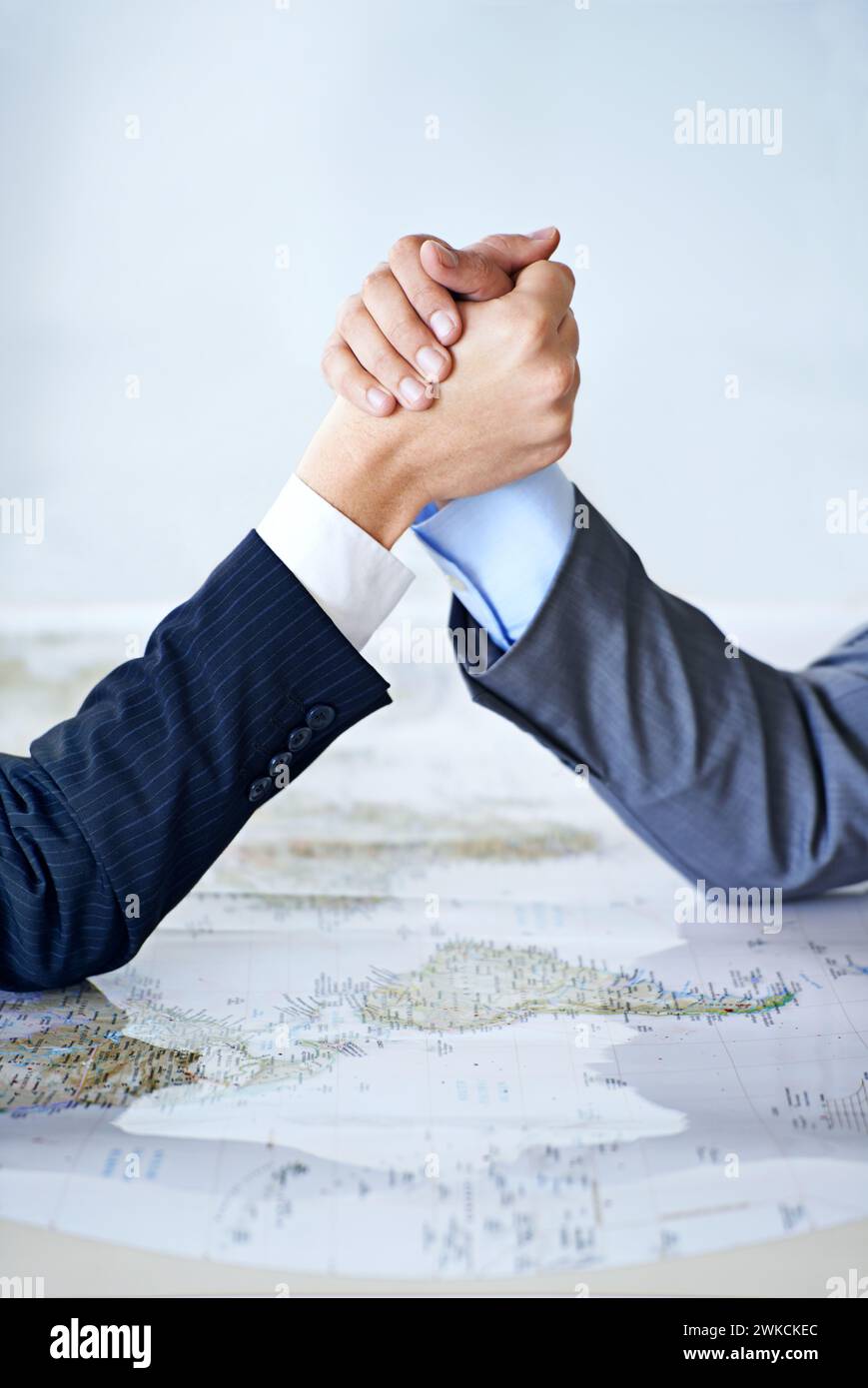 Map, arm wrestle and power struggle with business people in studio for ...