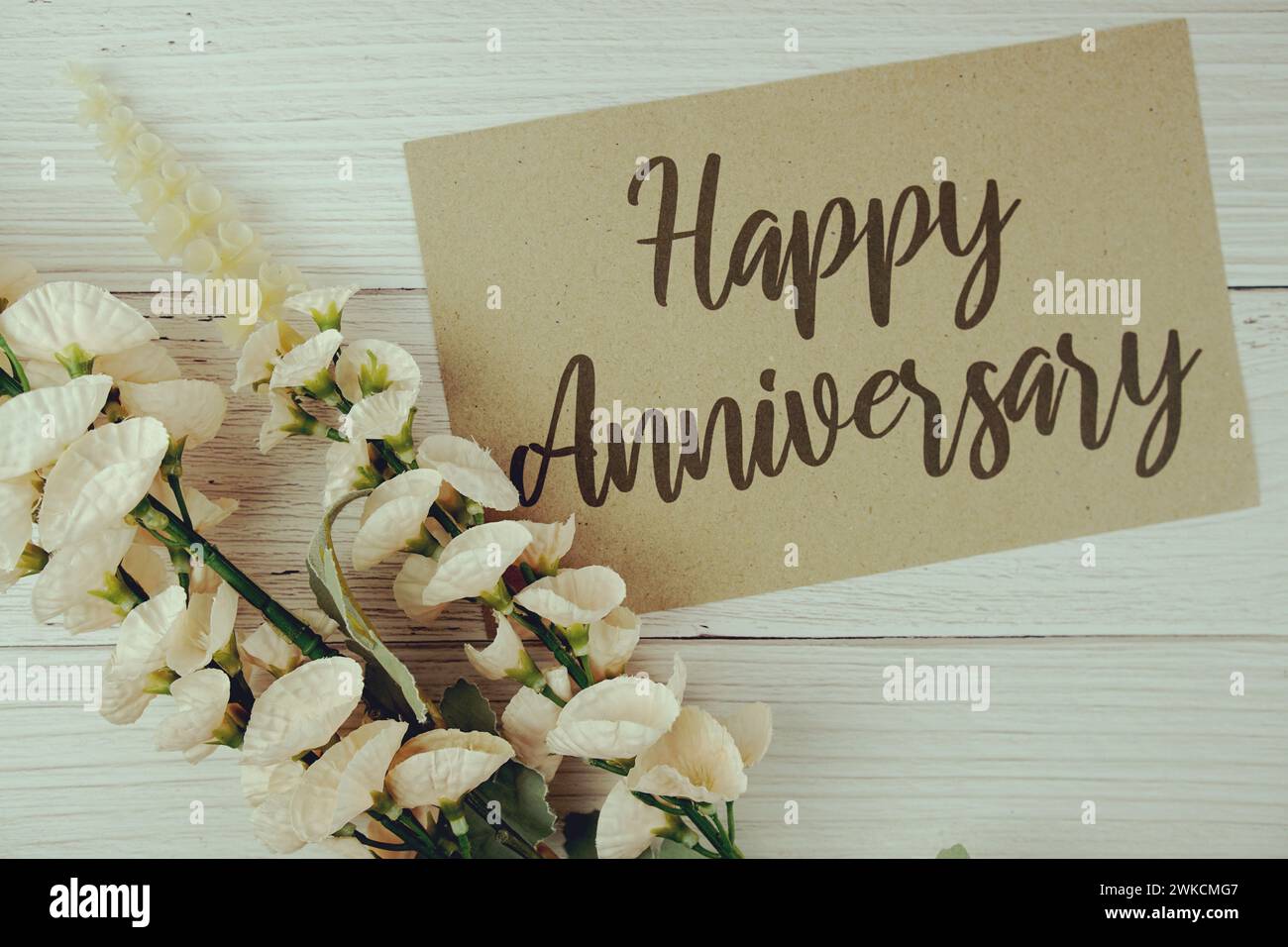 Happy Anniversary typography text on paper card decorate with flower on ...