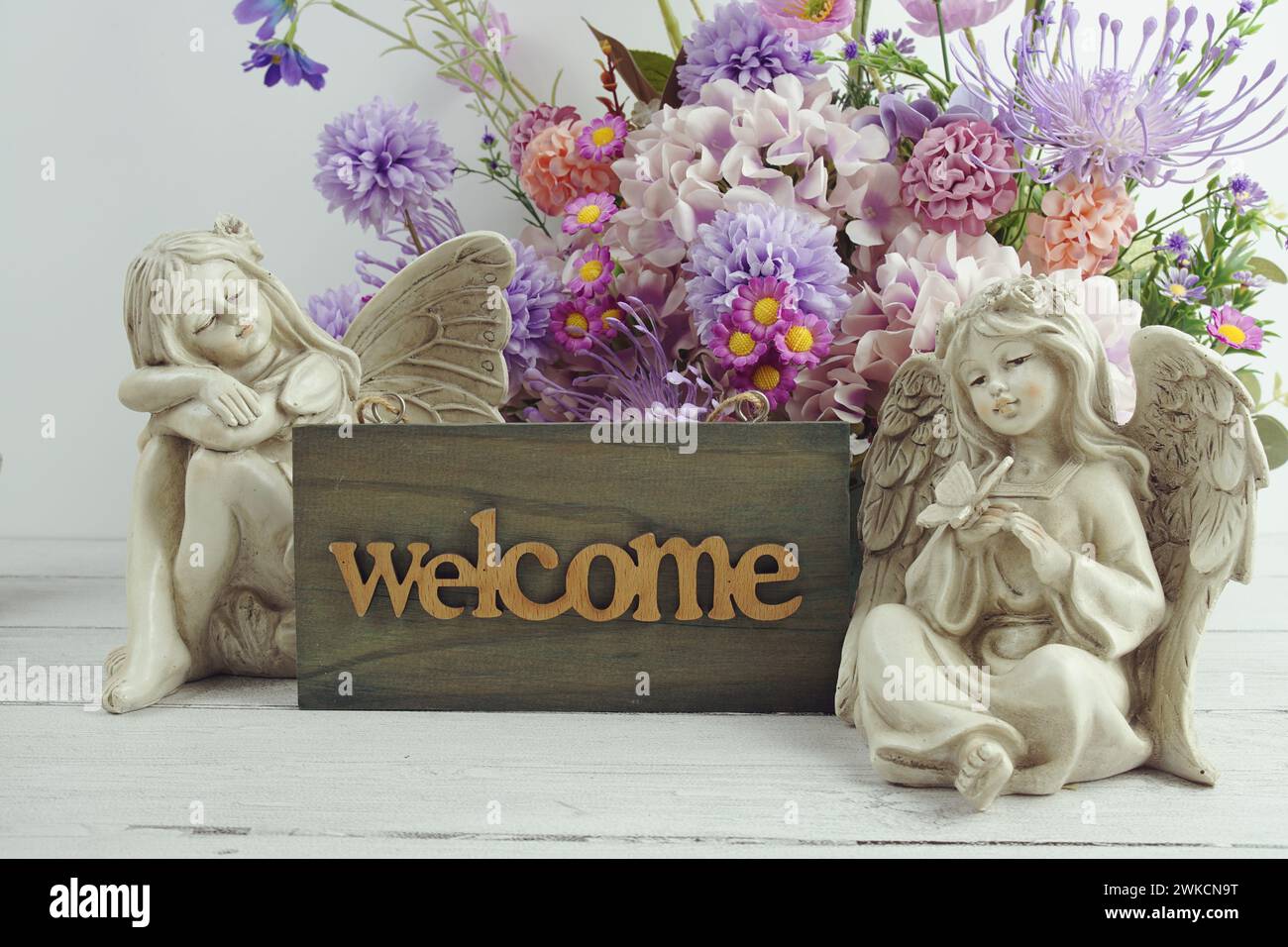 Welcome sign with flowers bouquet and angel statues home decorations ...