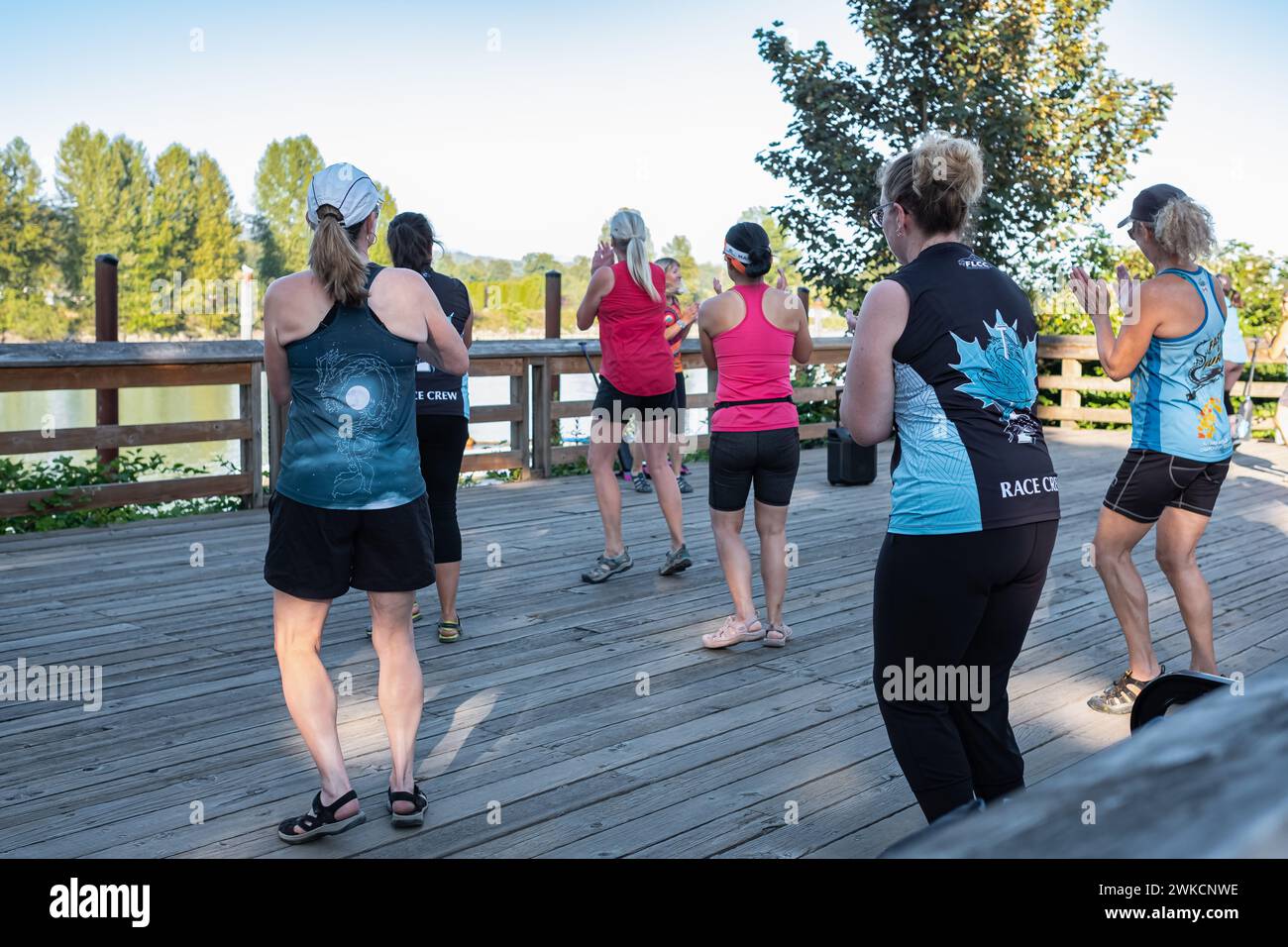 Group of women doing exercise in the park. Fitness class with ...