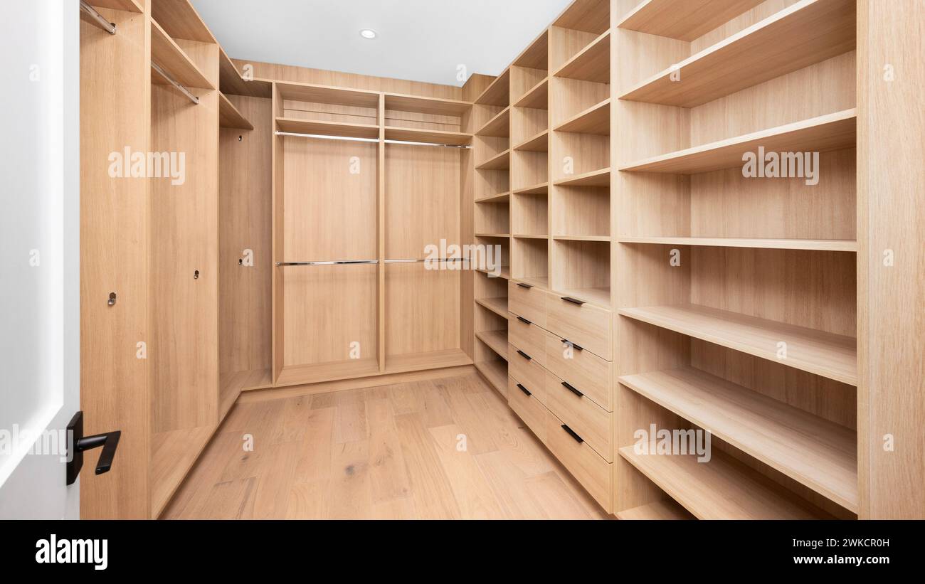 An empty walk-in closet with multiple wooden shelves Stock Photo - Alamy