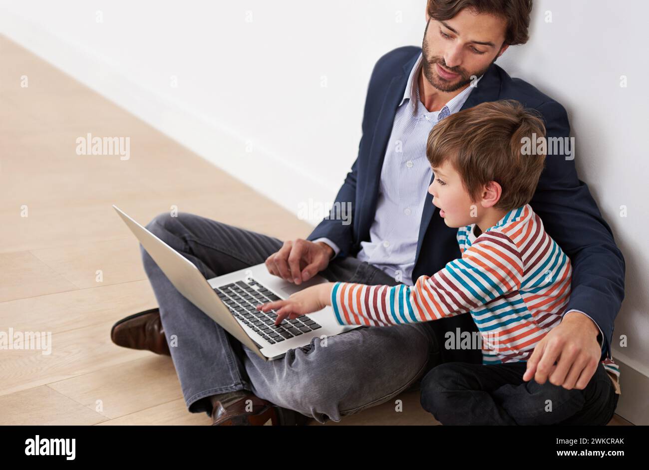 Father, kid and laptop on floor for learning, online education and ...