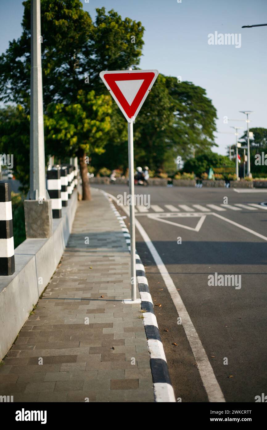 Triangular road sign, sign three-way junction on the road in Kediri ...