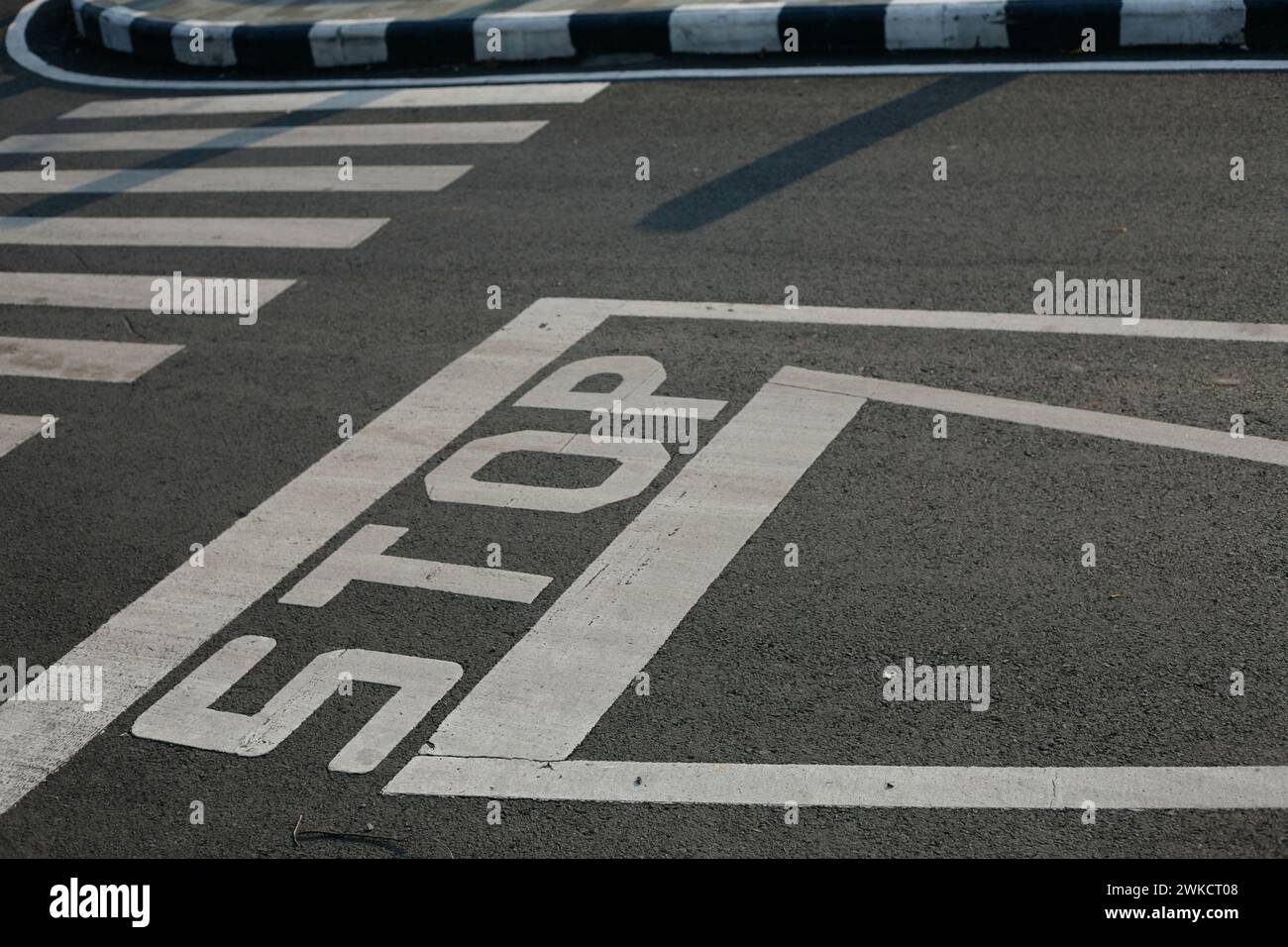Road junction, stop word marking on road in Kediri, East Java ...
