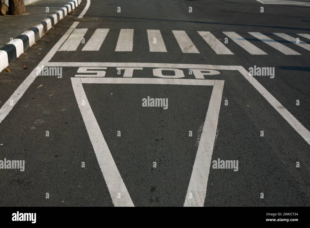 Road junction, stop word marking on road in Kediri, East Java ...