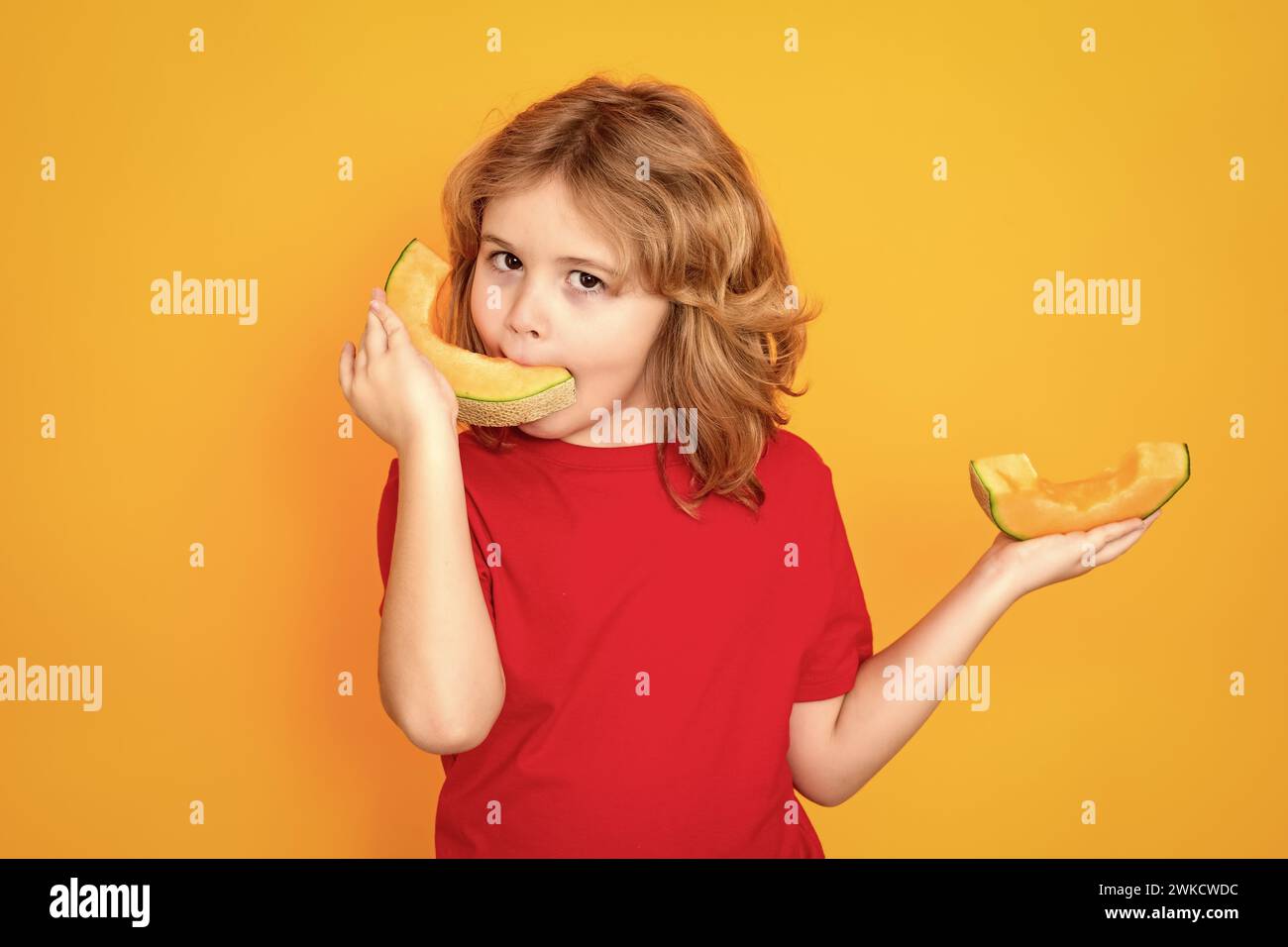 Kids face with fruits. Child eat red melon in studio. Melon fruit ...