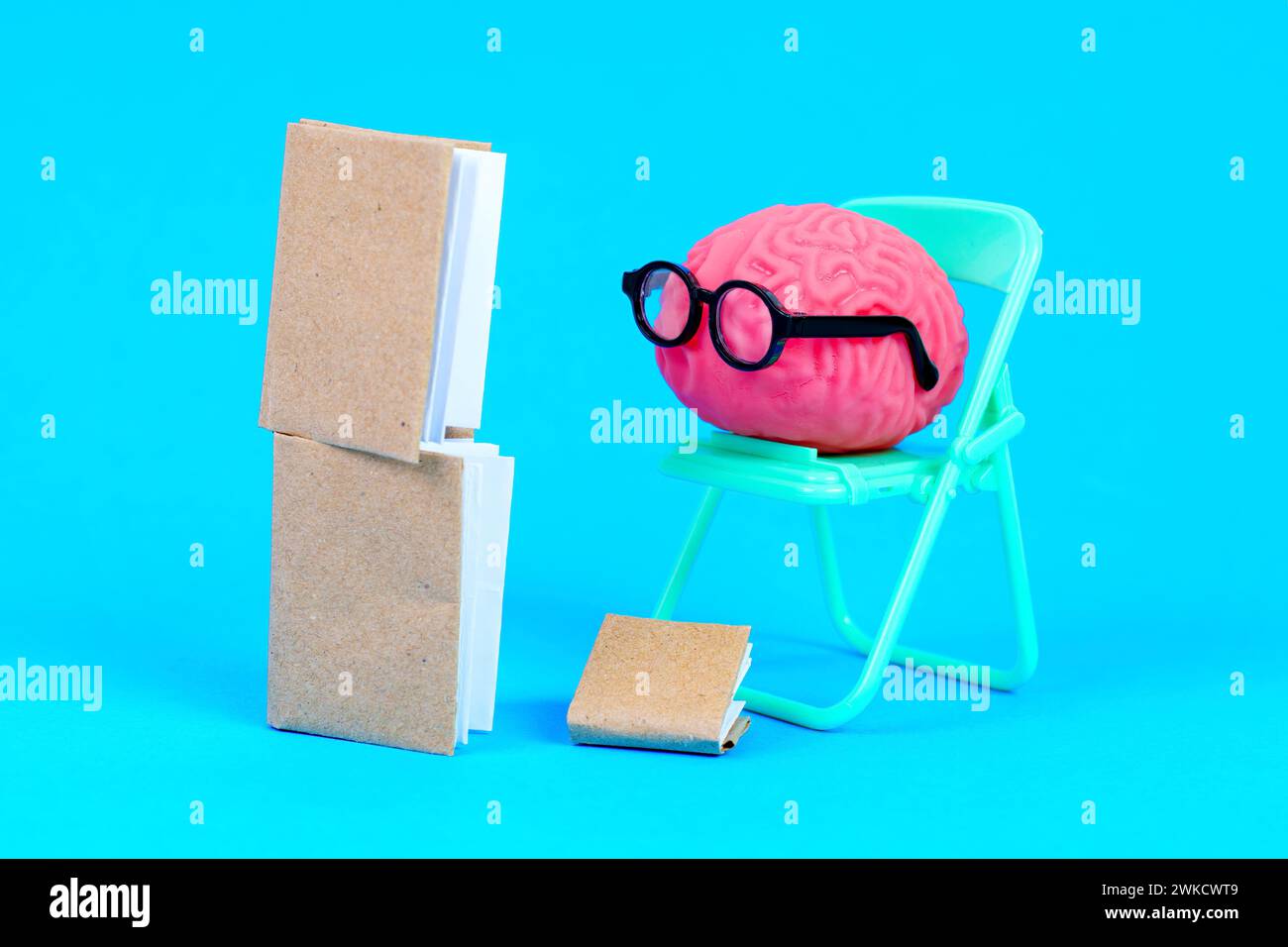 Pink human brain character adorned with glasses, seated on a teal ...