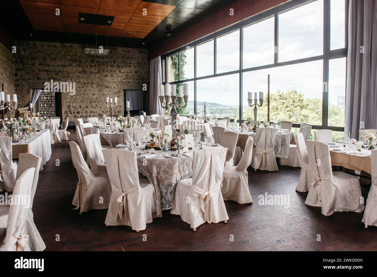 A cozy event space set with tables and chairs, ready for a wedding ...