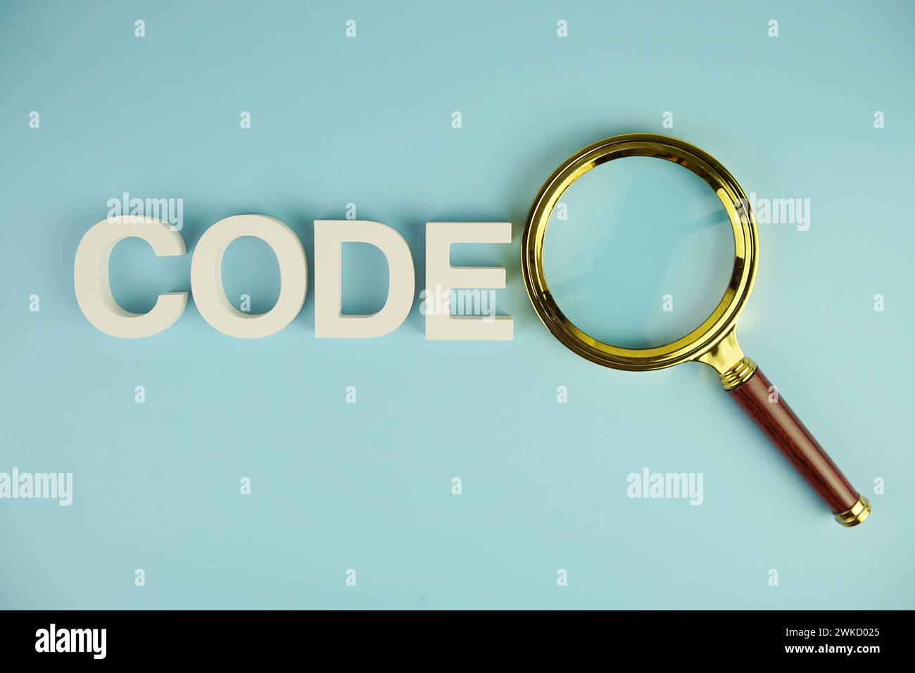 Code alphabet letters with magnifying glass on blue background Stock ...