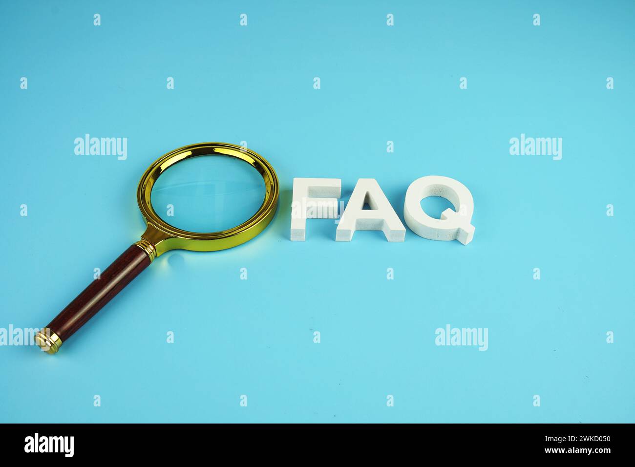 FAQ alphabet letters with magnifying glass on blue background Stock ...
