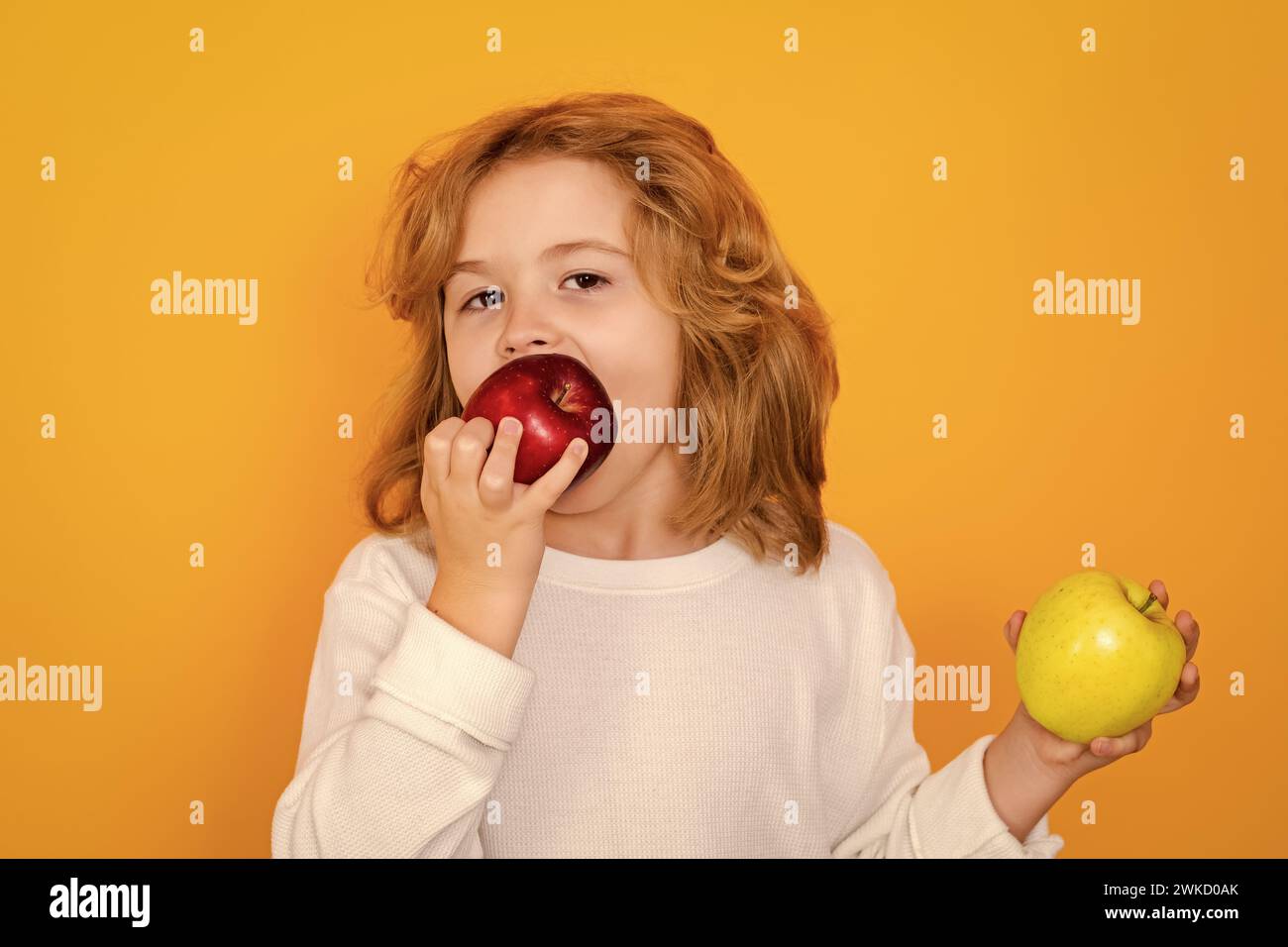 Healthy fruits for kids. Kid with apple in studio. Studio portrait of ...
