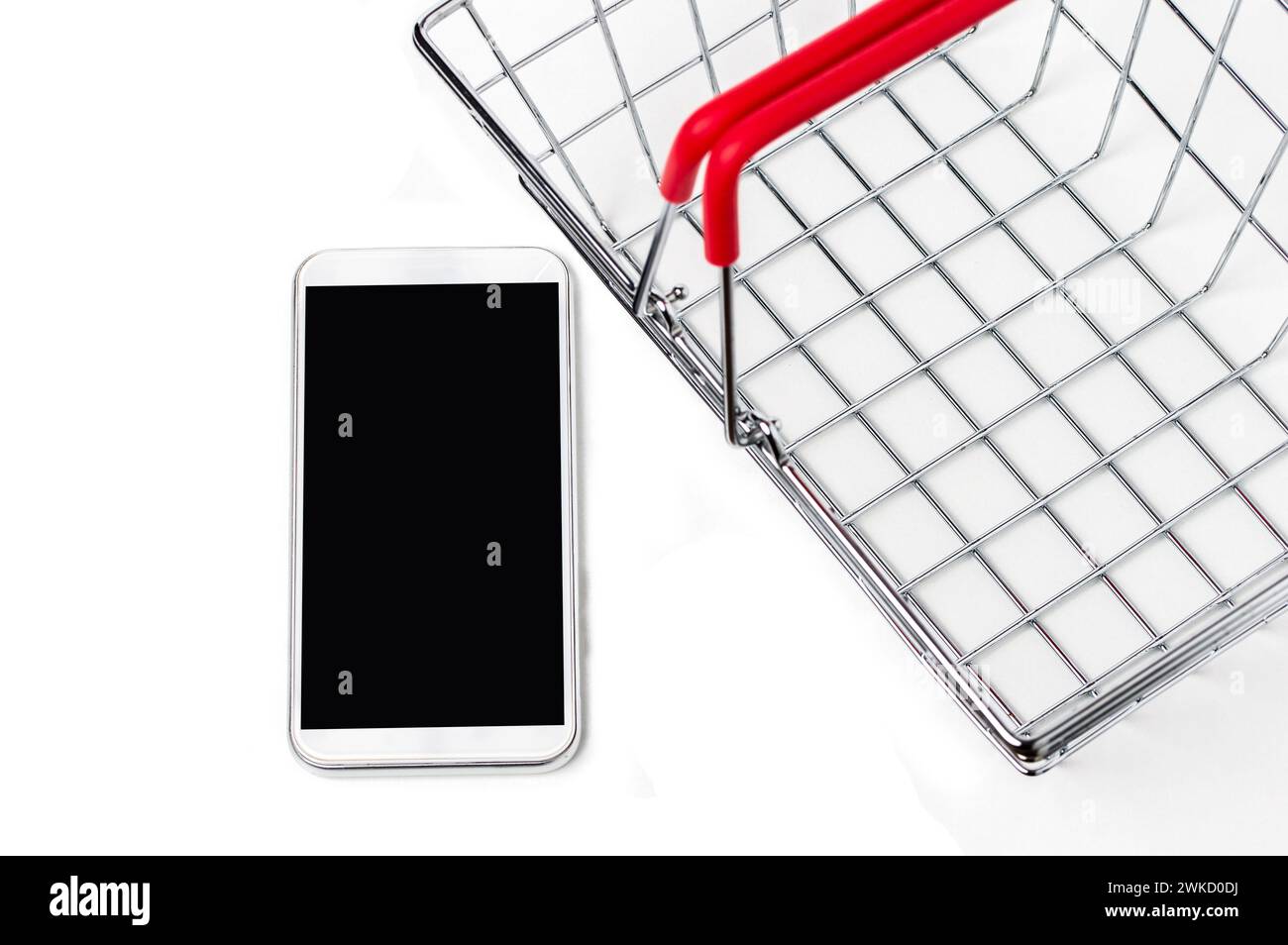 Smart phone and shopping basket metal on white background. Internet ...