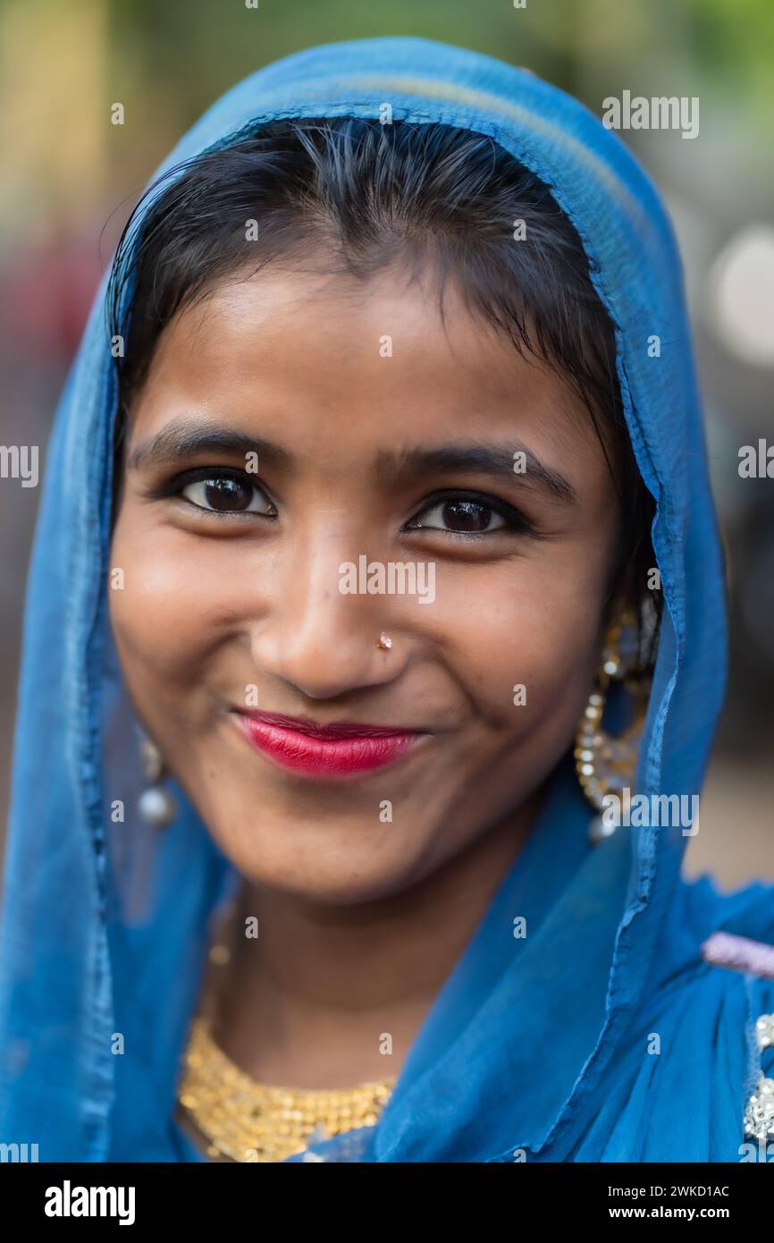 Closeup portrait of young hindu woman wearing blue veil, jewellery and ...