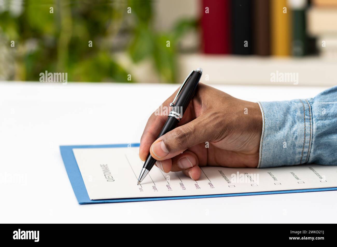 Close up of man hand filling form on a table at home or office Stock ...